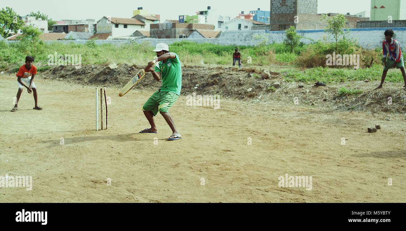 Young Boys playing cricket at filed on village Stock Photo - Alamy