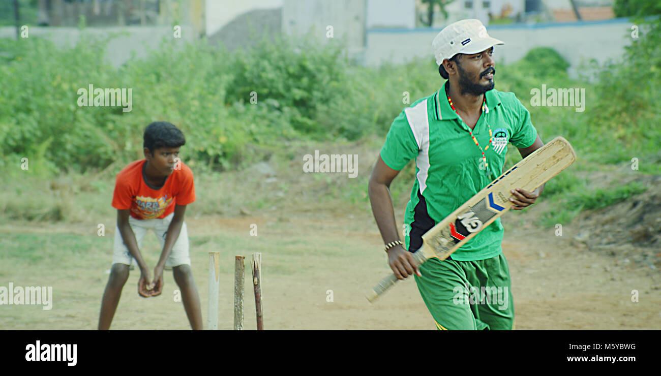 Boys playing cricket at field Stock Photo - Alamy