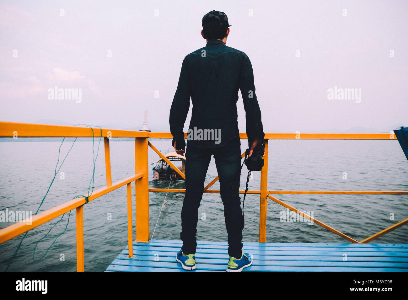 One man Travel around the world with one camera,Man holding camera on ...