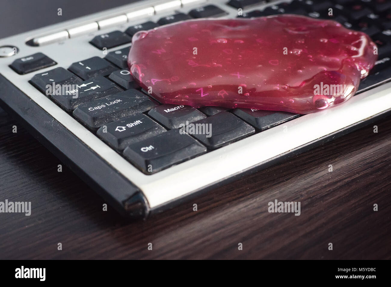 The red slime spread on the computer keyboard. Tools for quick cleaning ...