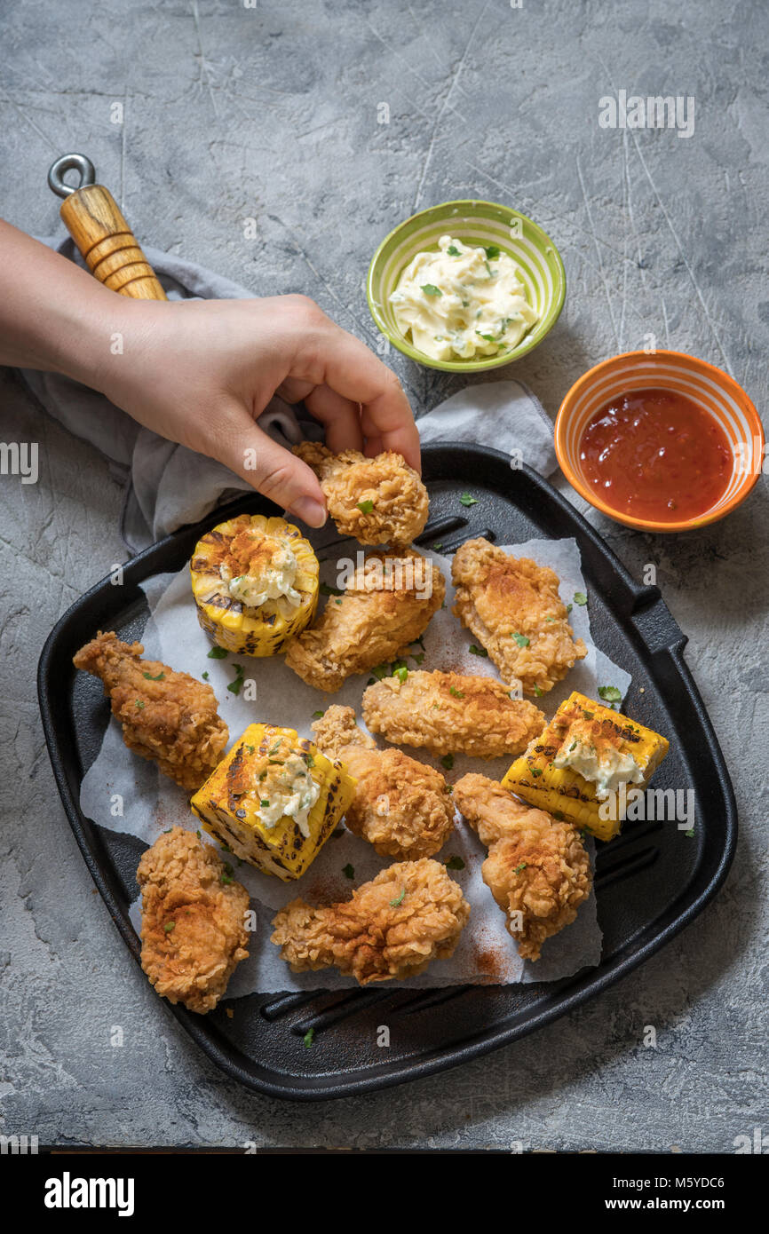 crispy kentucky fried chicken wings with grilled corn Stock Photo - Alamy