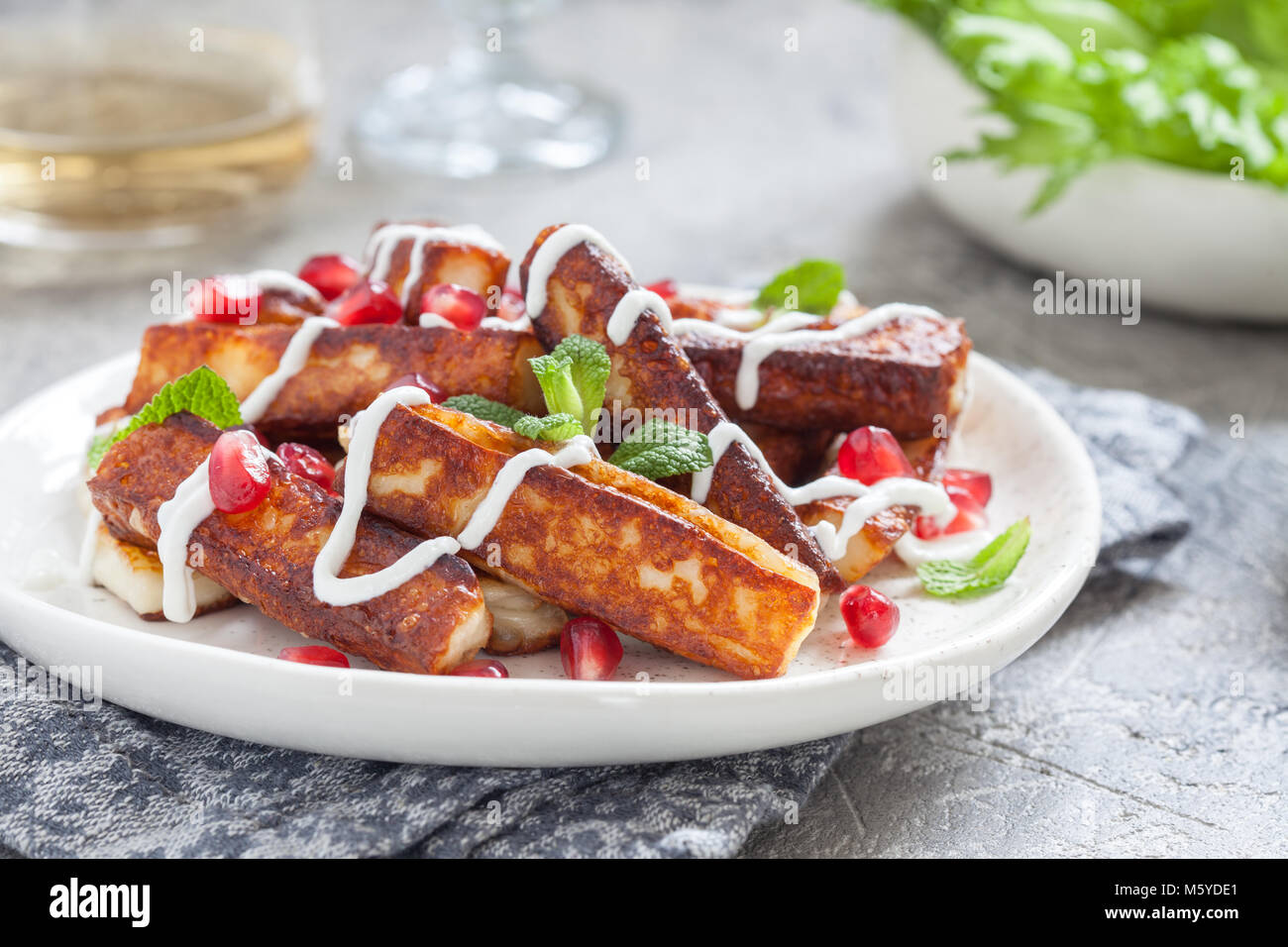 Crispy Halloumi cheese sticks Fries with yogurt sauce, pomegranate ...