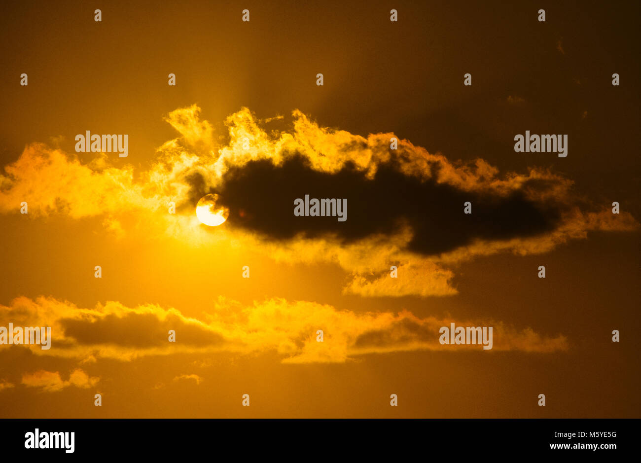 An intense sunset as the sun emerges from behind cloud coverage Stock ...