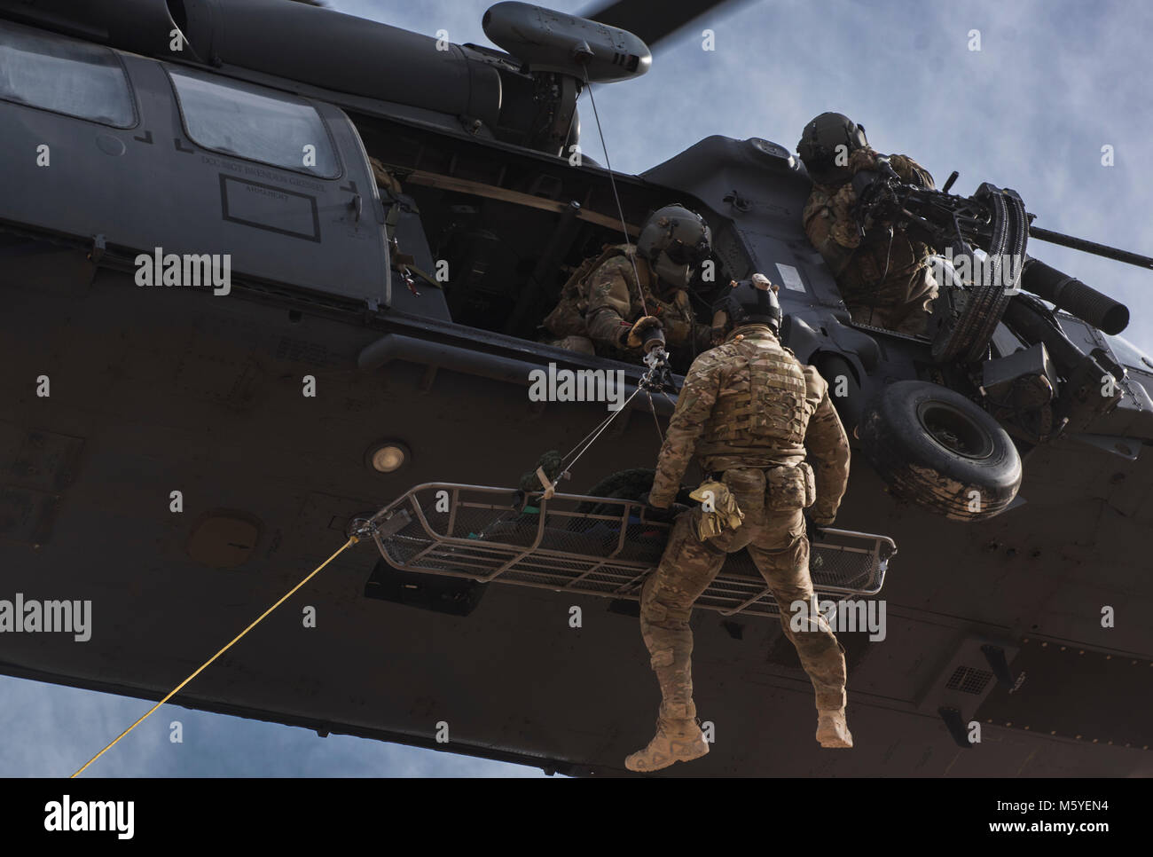 A pararescueman is hoisted into an HH-60G Pave Hawk helicopter, assigned to the 66th Rescue ...