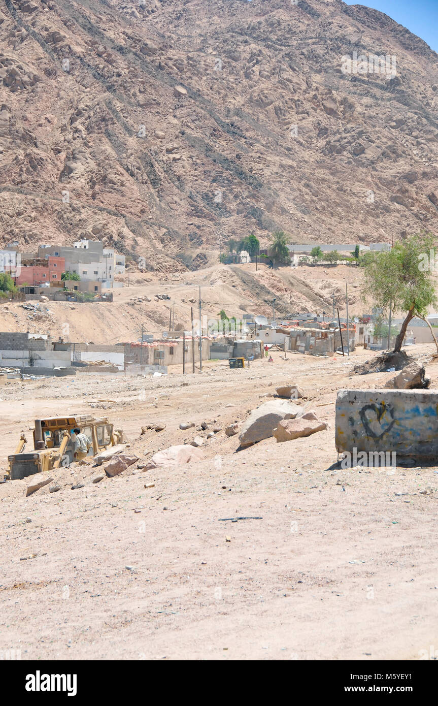 An informal settlement demolished in Aqaba in Jordan with modern houses ...