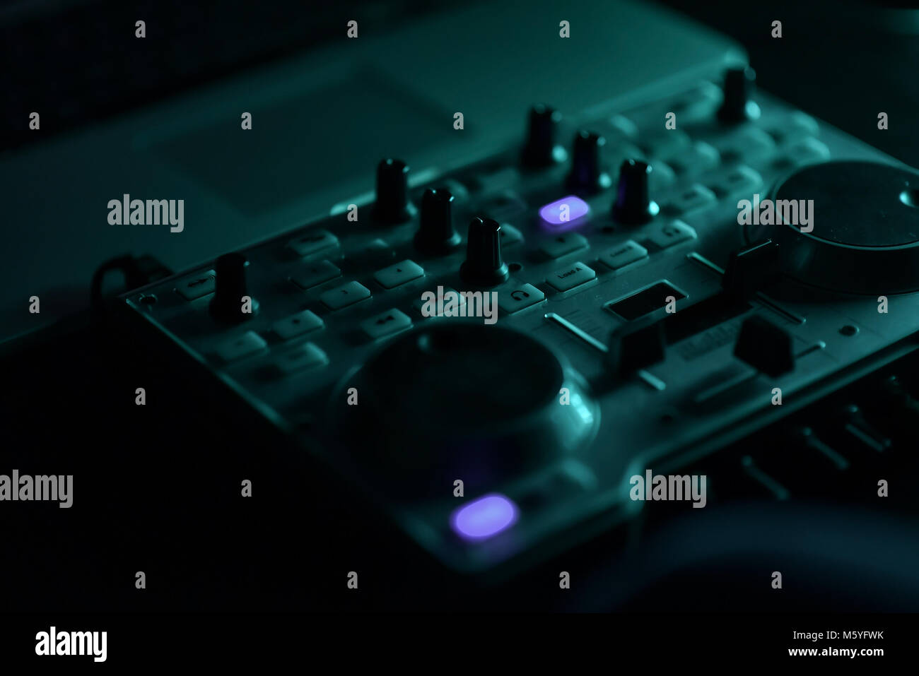 DJ mixer disco illuminated by searchlights Stock Photo - Alamy