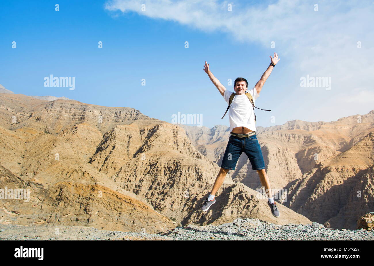 Man jumping on the mountain top with a view Stock Photo - Alamy