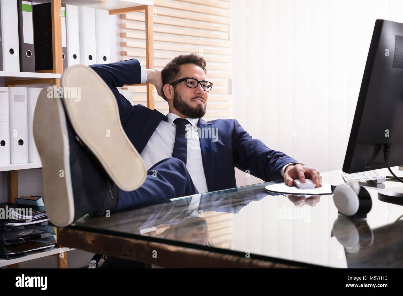 Relaxed Young Businessman Working On Computer At Workplace Stock Photo ...