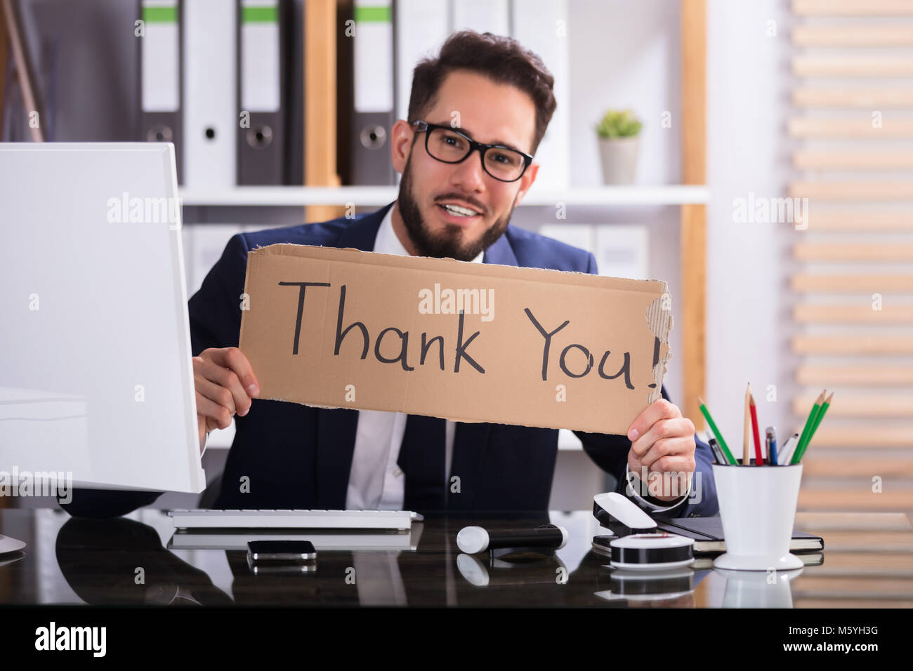 Smiling Young Businessman Holding Cardboard With Thank You Text In ...