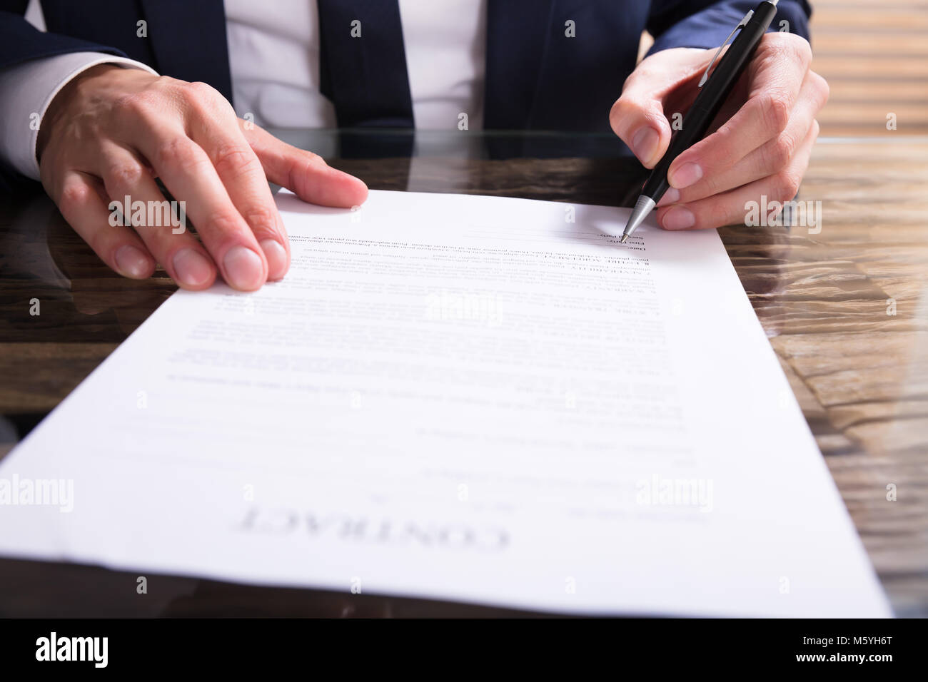 Close-up Of A Businessperson's Hand Filling Contract Form Stock Photo ...