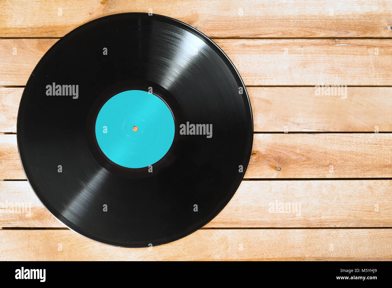 Record plate on wooden background Stock Photo - Alamy