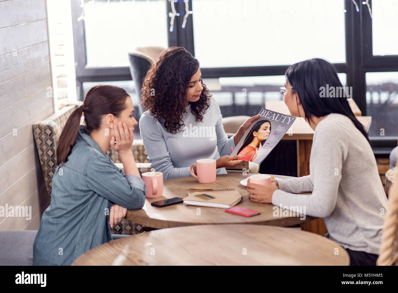 Attractive three friends discussing model Stock Photo - Alamy
