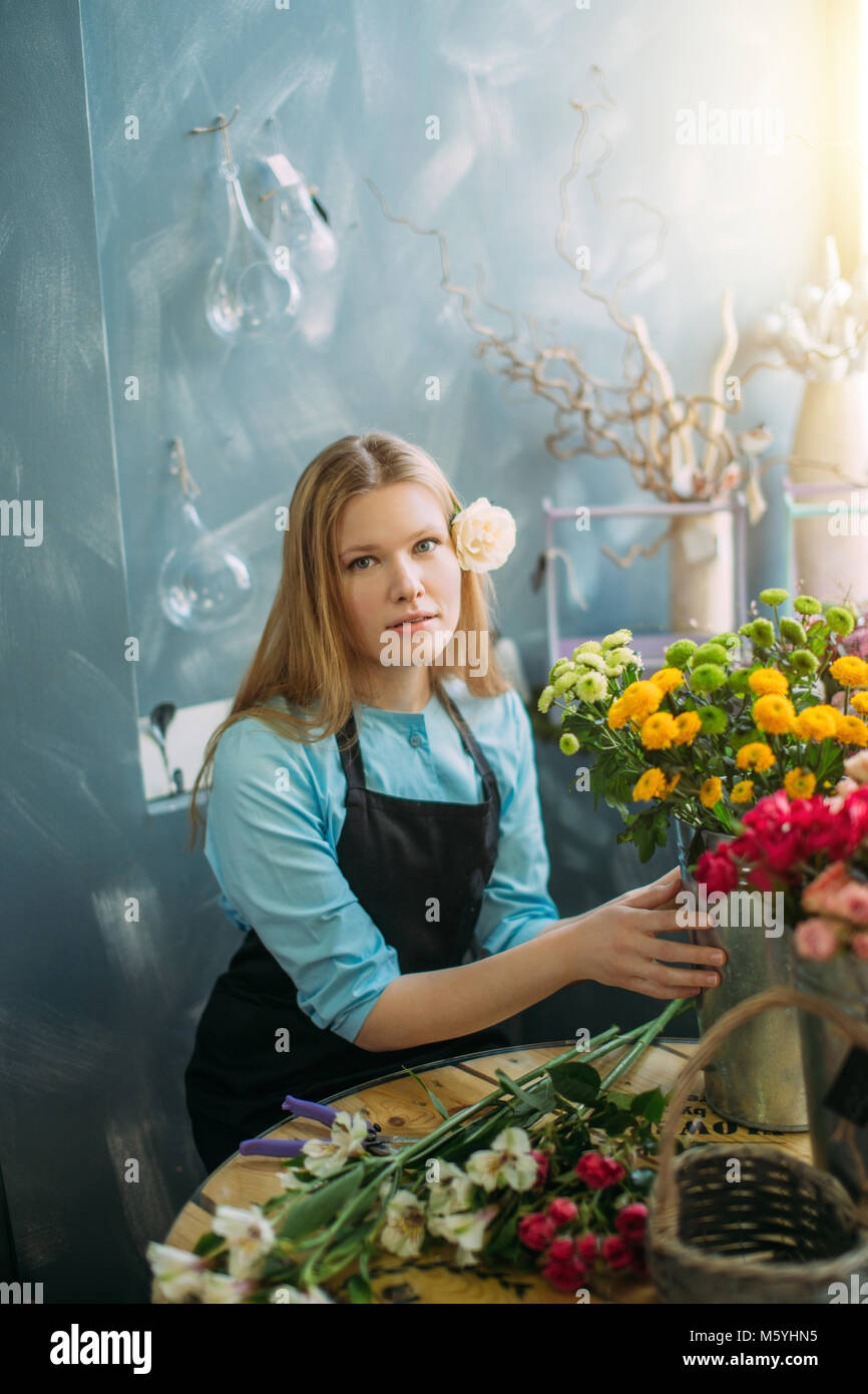 blonde posing to the camera at flower shop Stock Photo - Alamy