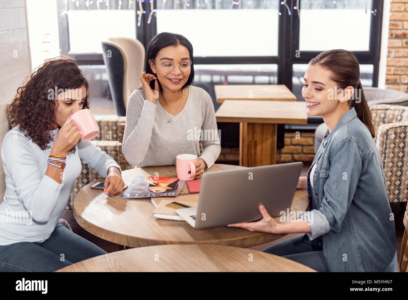 Skillful three students compiling plan Stock Photo - Alamy