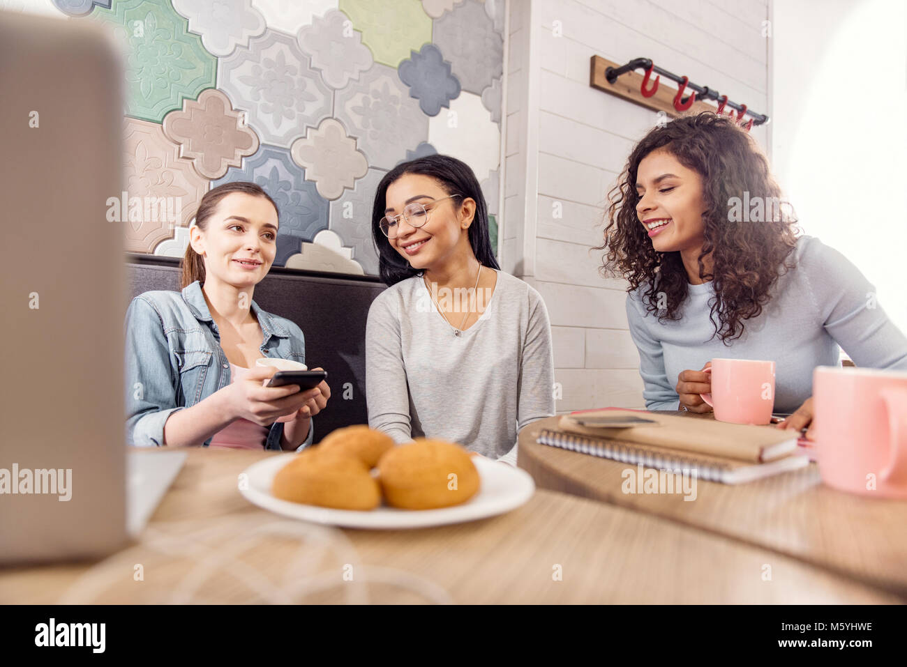 Pensive three friends sharing secrets Stock Photo - Alamy