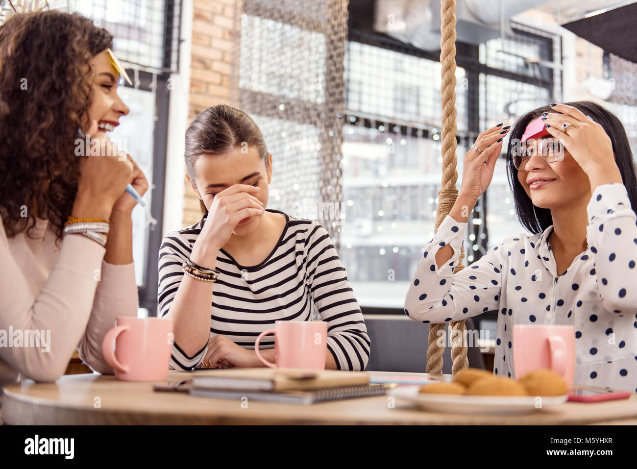 Adorable three friends having game competition Stock Photo - Alamy