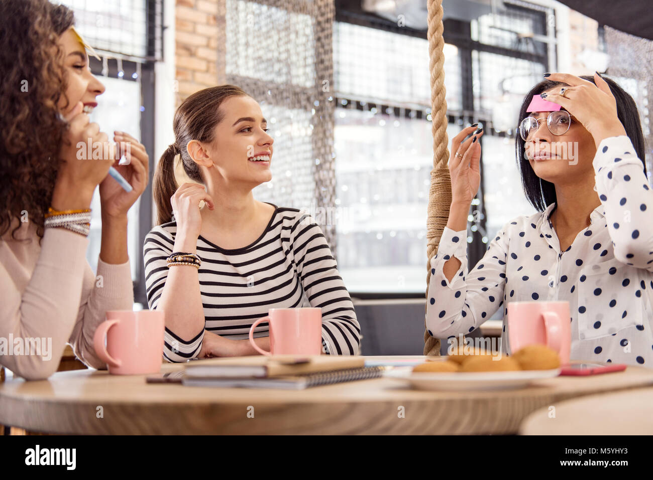 Beautiful three friends starting game Stock Photo - Alamy