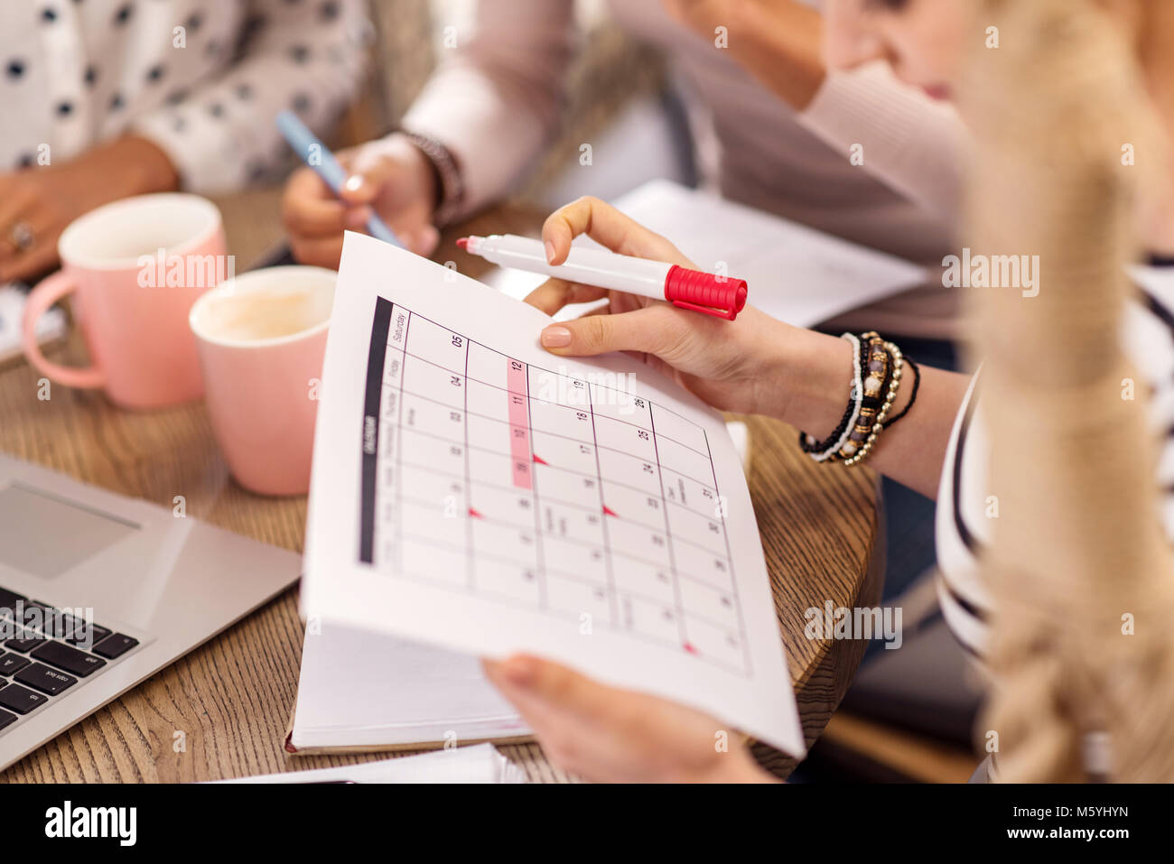 Tender female hands holding calendar Stock Photo - Alamy
