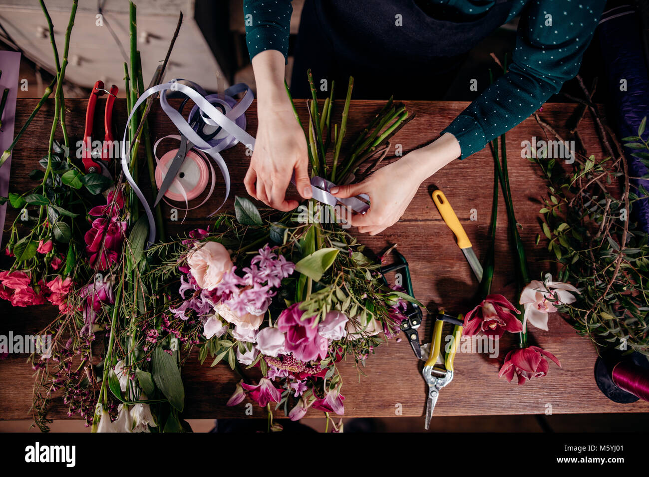photo of woman adding roses together Stock Photo - Alamy