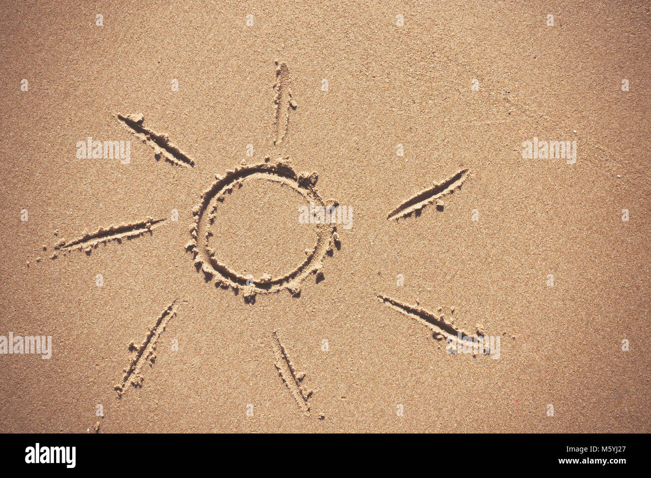 Sun drawing on beach sand Stock Photo - Alamy
