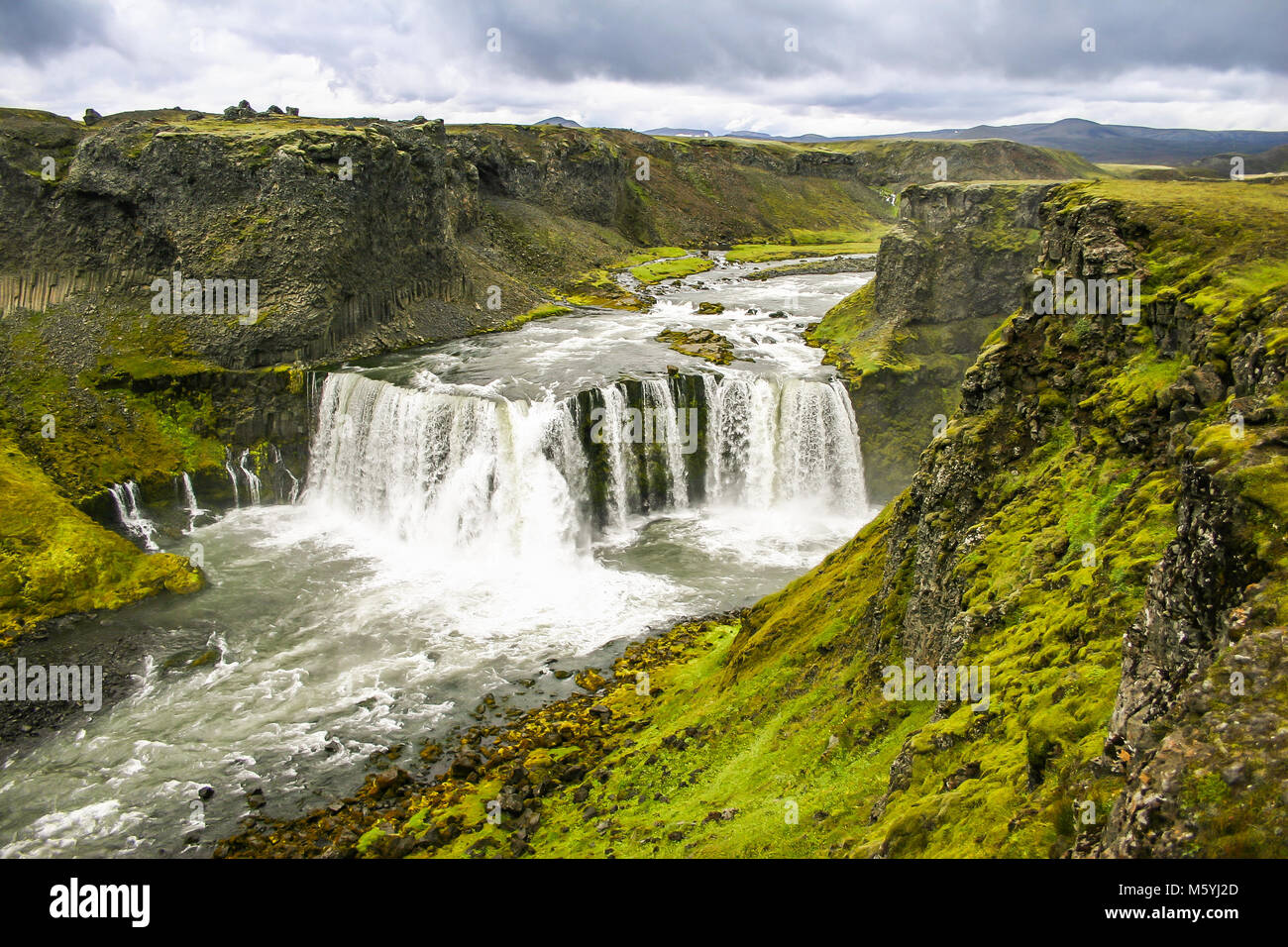 waterfall in green iceland landscape Stock Photo - Alamy