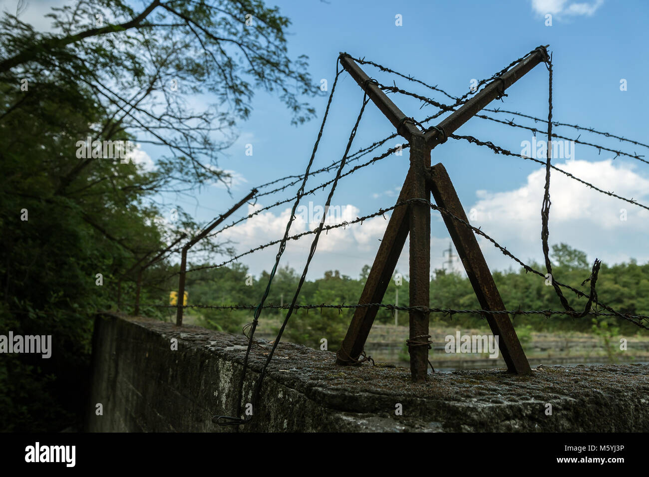 Barbed wire of protection to a high wall Stock Photo - Alamy