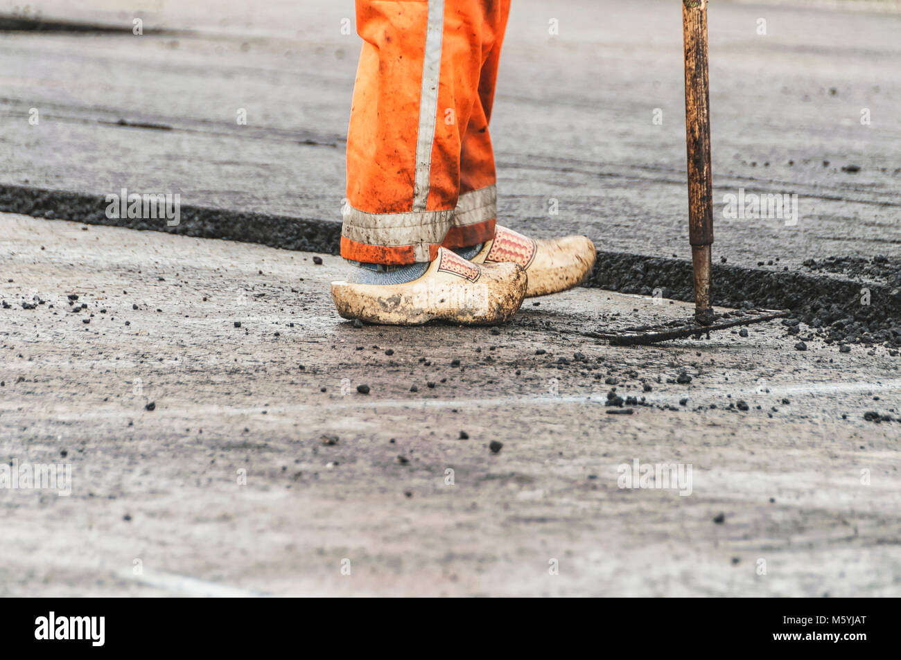 asphalt worker wearing Dutch wooden clogs Stock Photo - Alamy