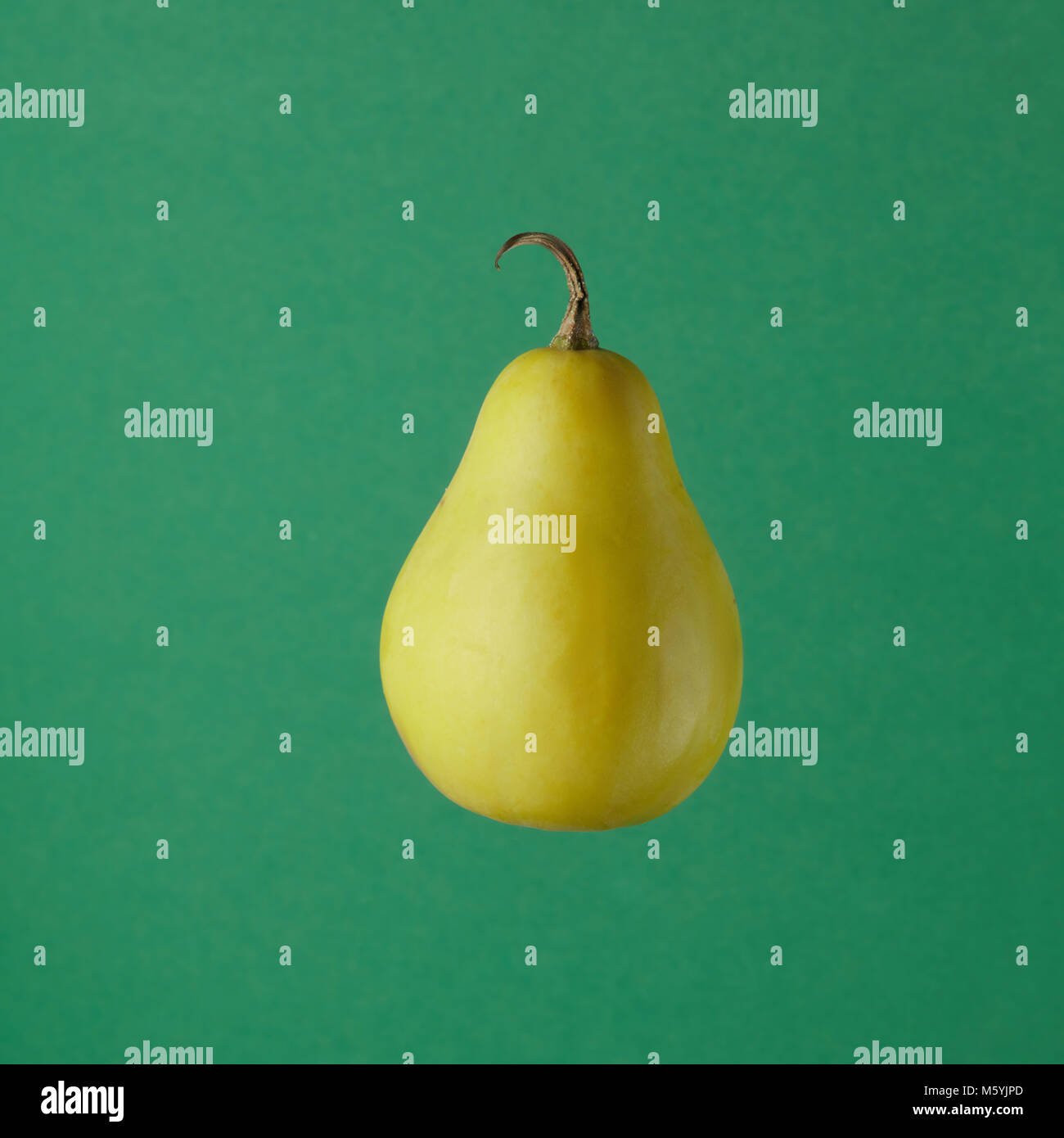Creative concept with flying pear isolated on green Stock Photo - Alamy