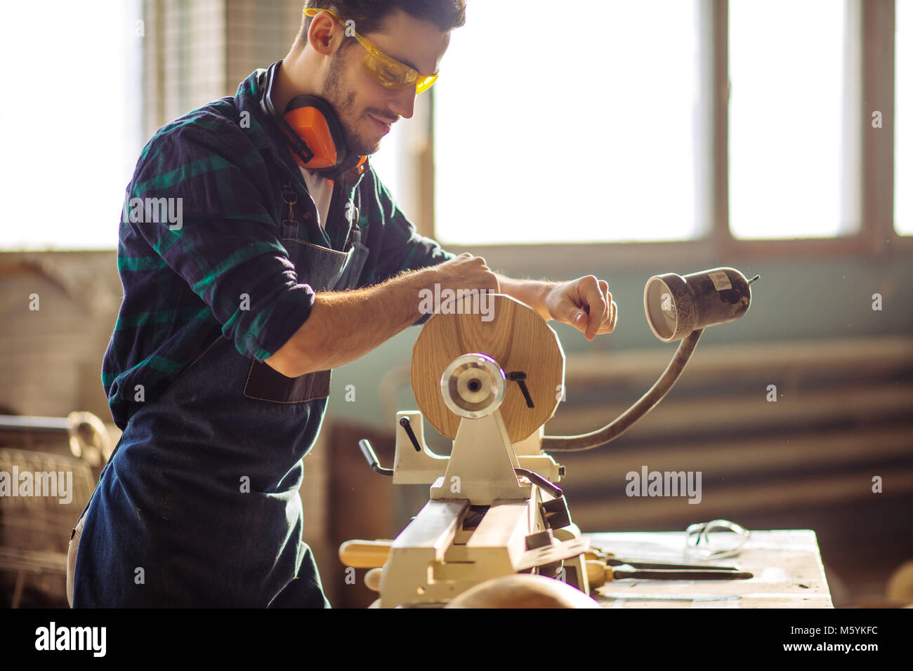 attractive man begin doing woodwork in carpentry Stock Photo - Alamy