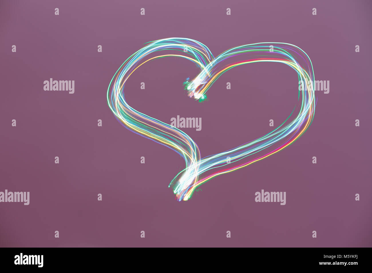 The heart-shaped digital neon lights are on the purple background Stock ...