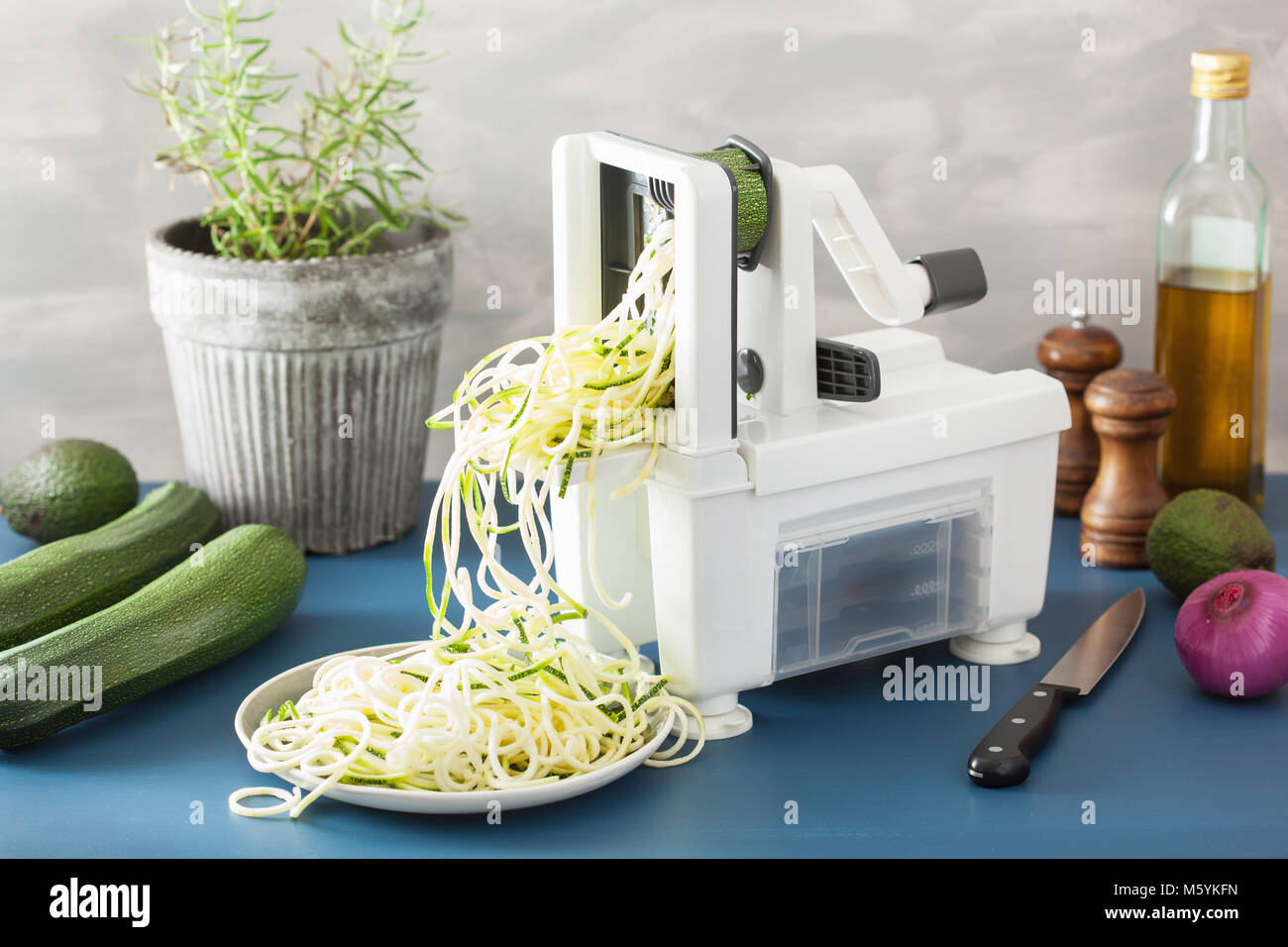 spiralizing courgette raw vegetable with spiralizer Stock Photo - Alamy