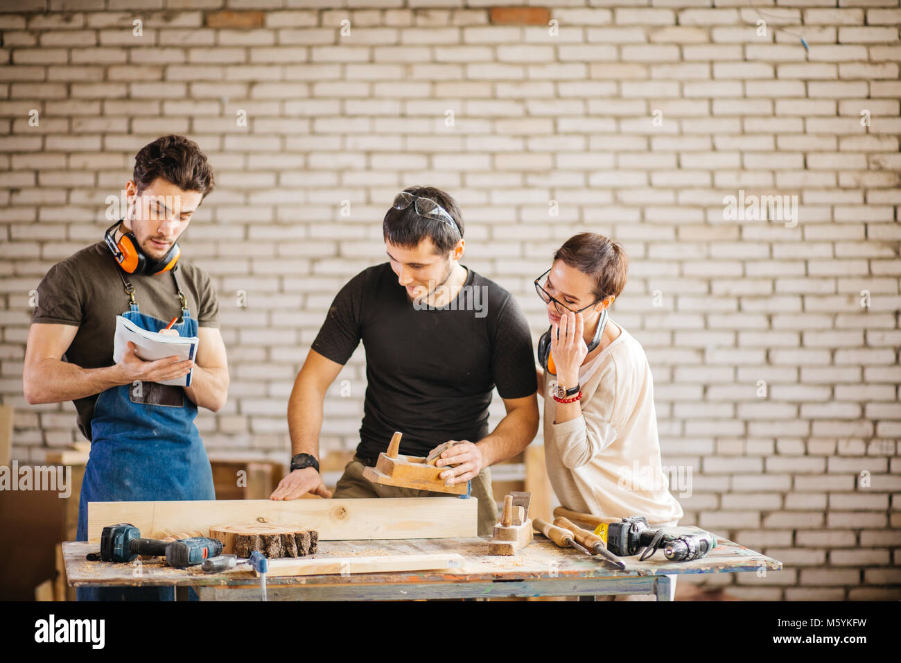 carpenter with students in woodworking workshop Stock Photo - Alamy