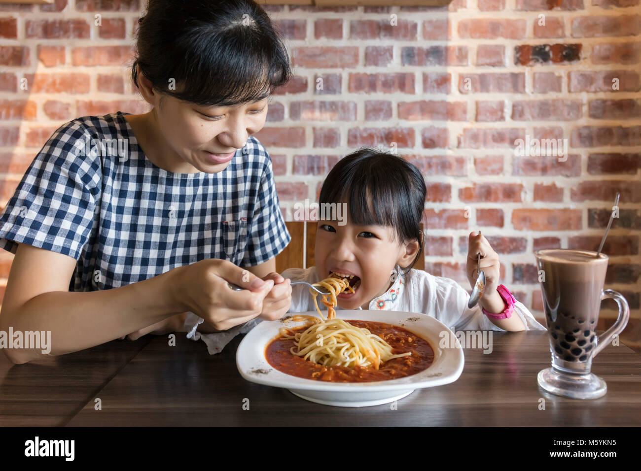 Family eating spaghetti bolognese hi-res stock photography and images ...