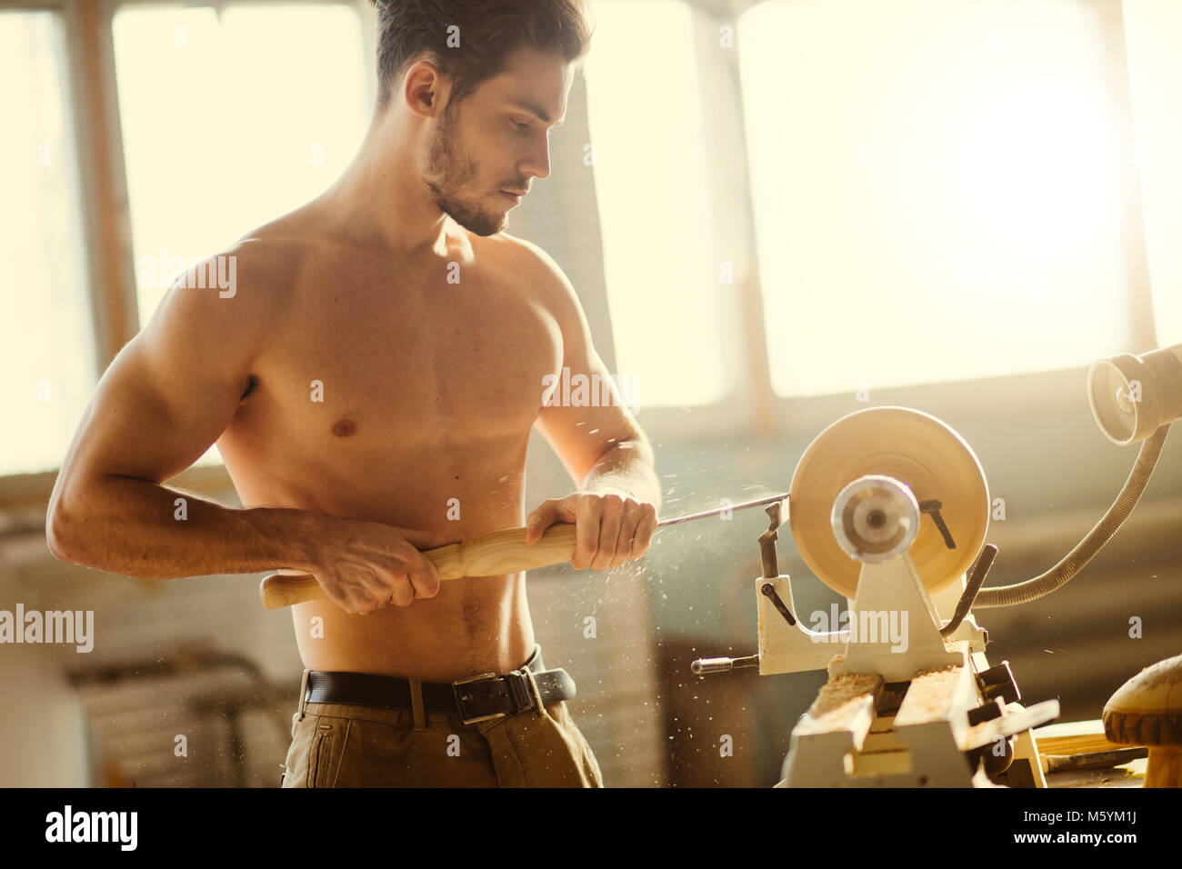 Wood lathe. Carpenter lathing wood Stock Photo - Alamy