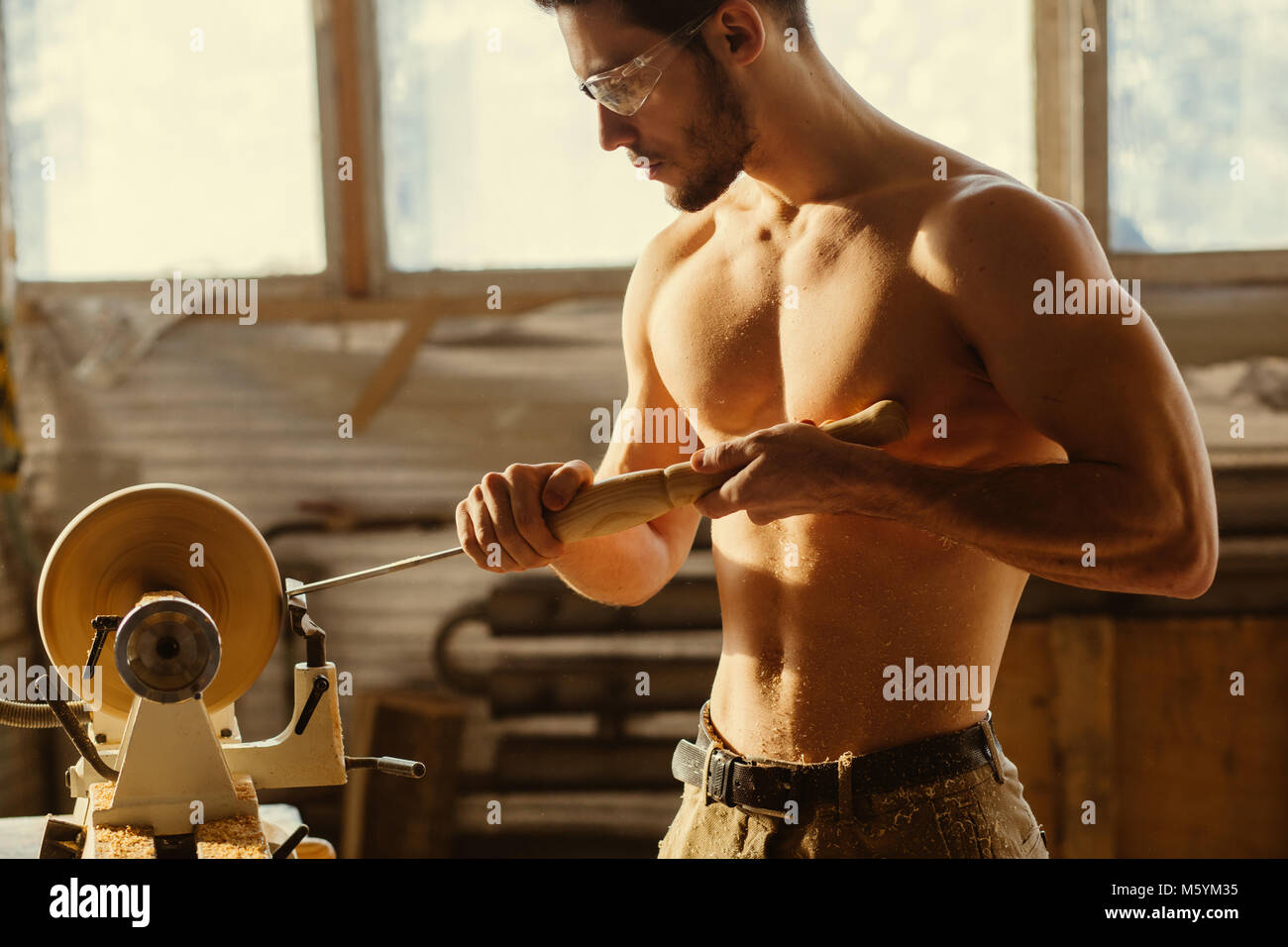 Wood lathe. Carpenter lathing wood Stock Photo - Alamy