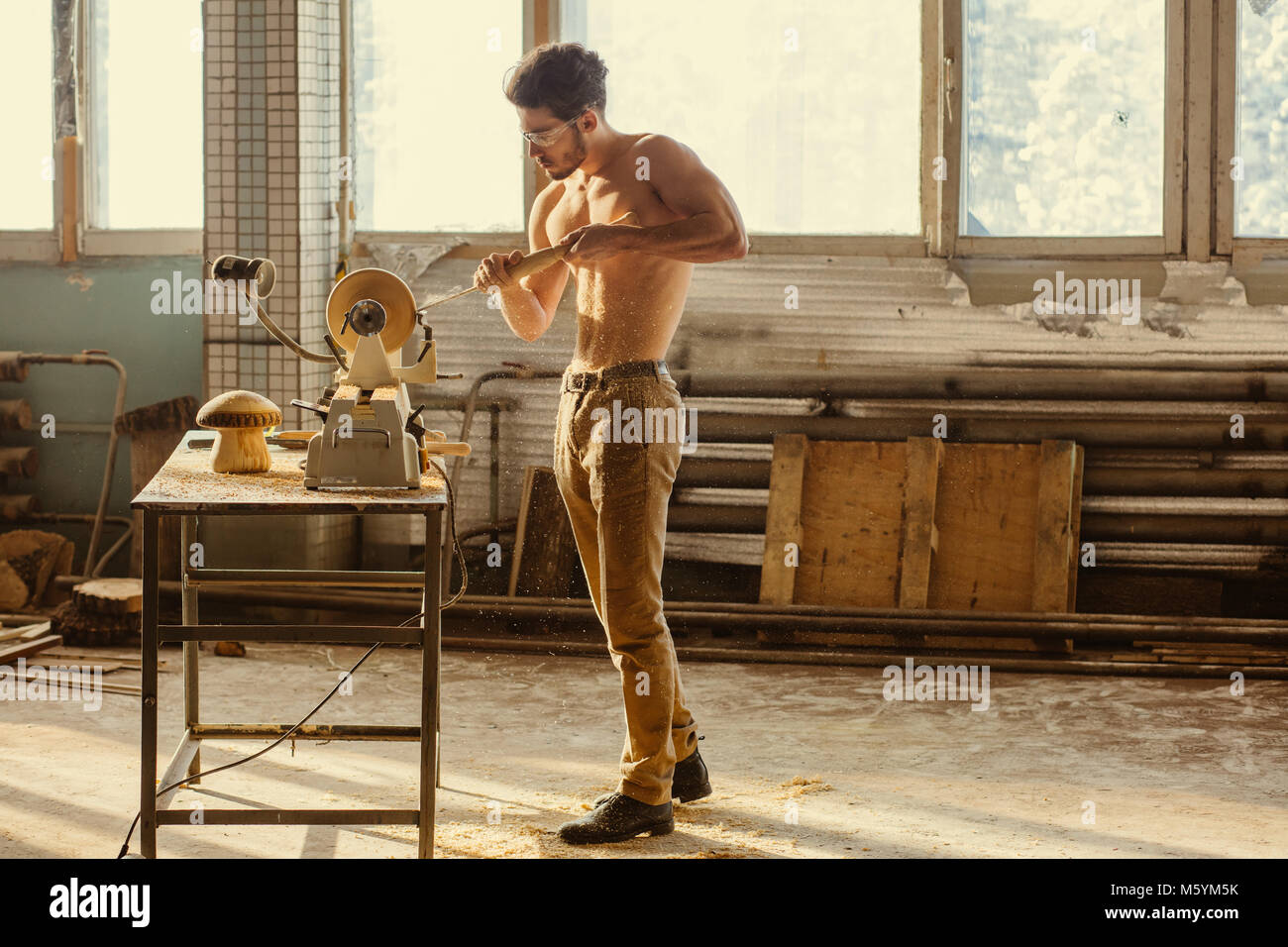 Wood lathe. Carpenter lathing wood Stock Photo - Alamy