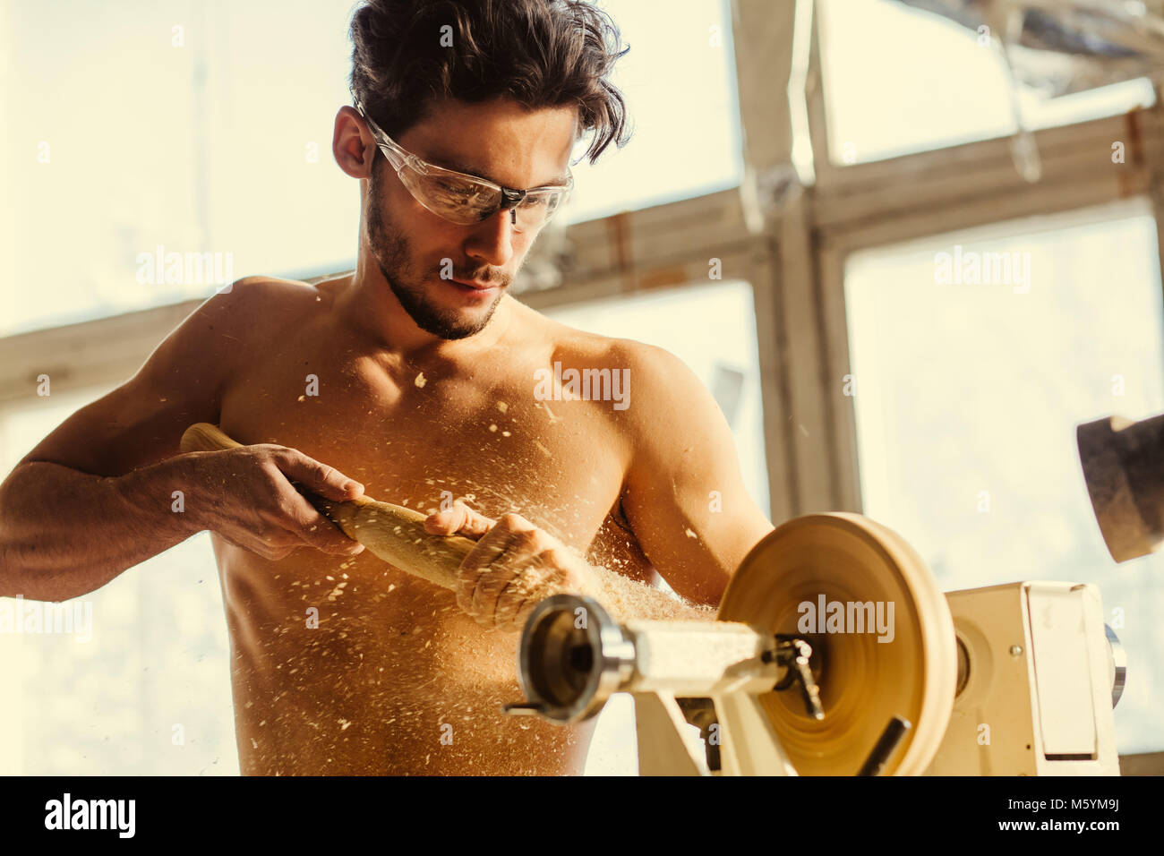 Wood lathe. Carpenter lathing wood Stock Photo - Alamy