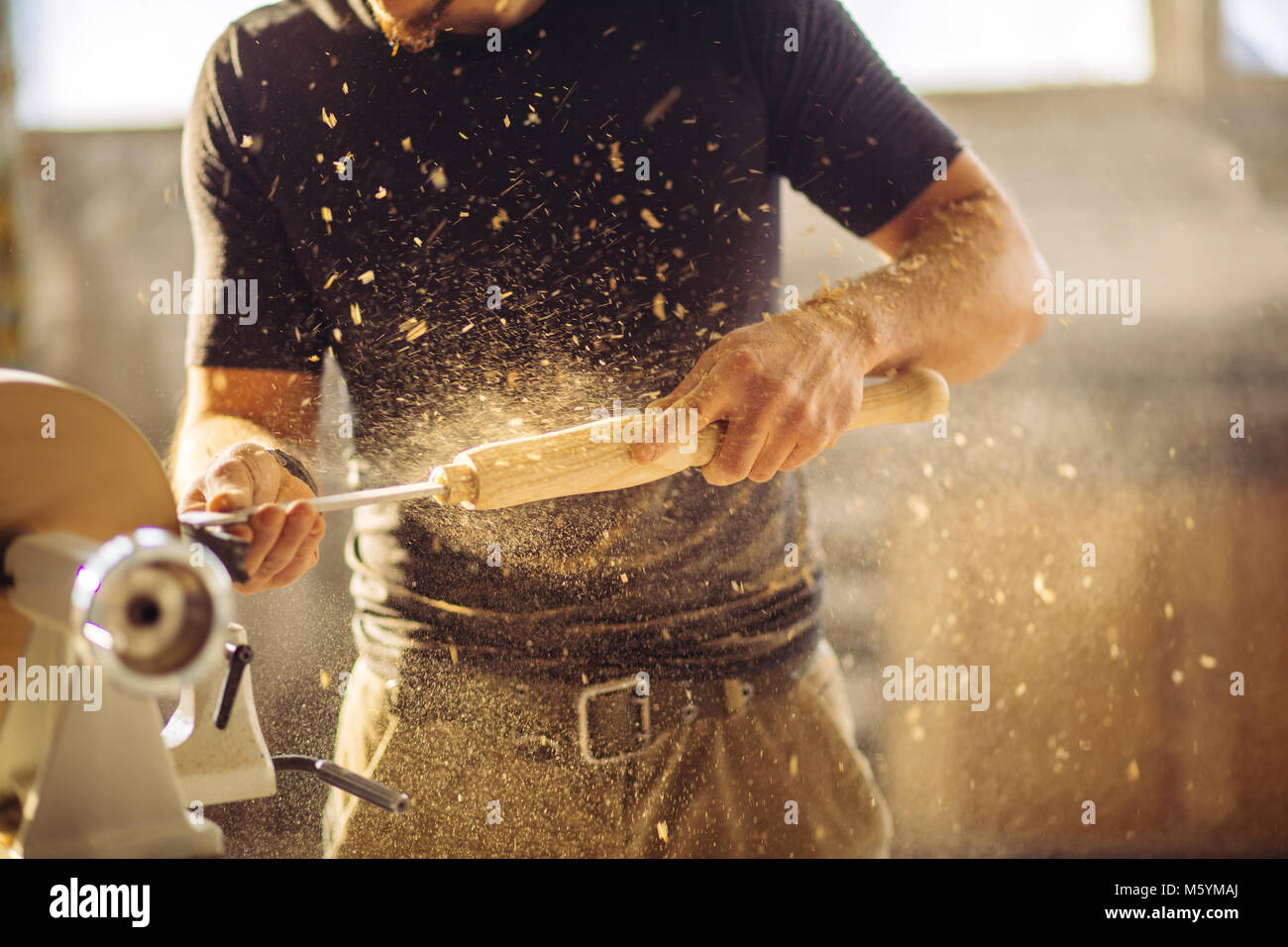 Wood lathe. Carpenter lathing wood Stock Photo - Alamy