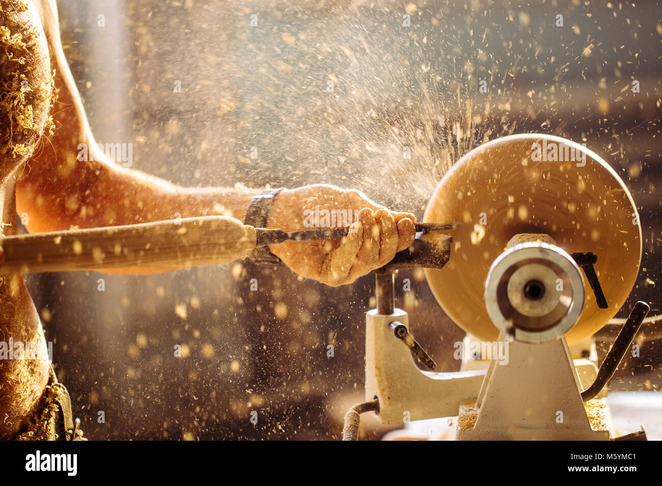 Wood lathe. Carpenter lathing wood Stock Photo - Alamy