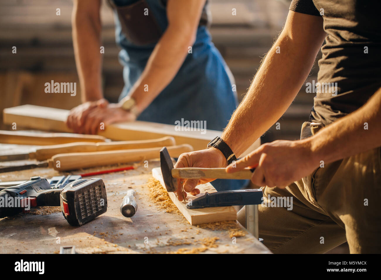 carpenter with students in woodworking workshop Stock Photo - Alamy