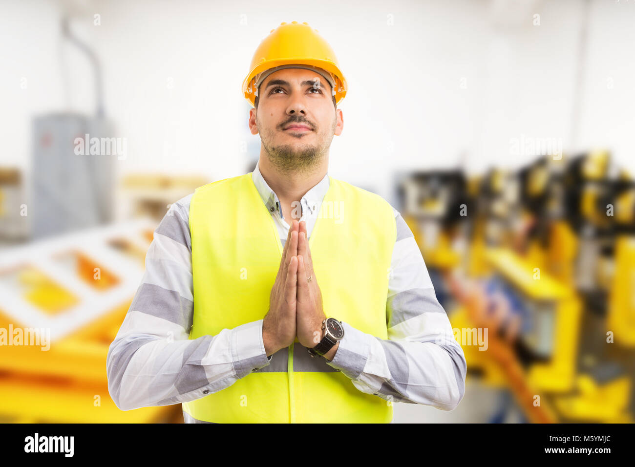 Factory worker technician or engineer praying gesture as hope wish ...