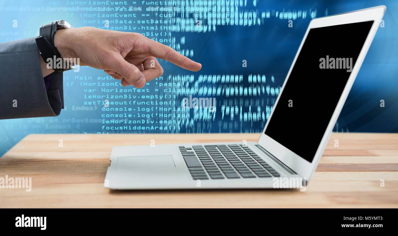 Hand pointing at laptop with coding text Stock Photo - Alamy