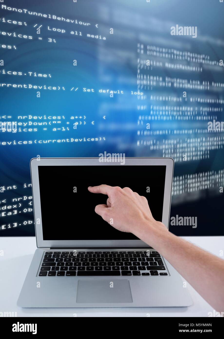 Hand touching laptop with coding text Stock Photo - Alamy