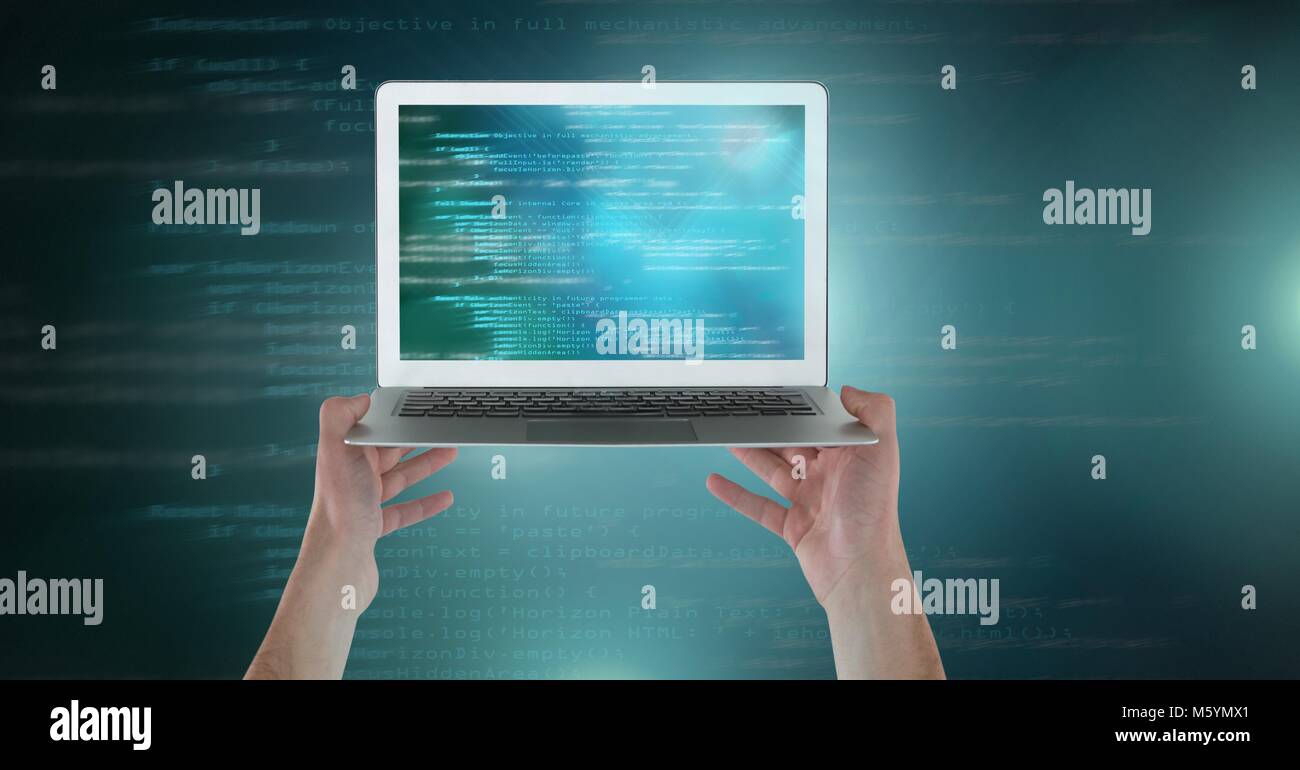 Hands holding laptop with coding text Stock Photo - Alamy