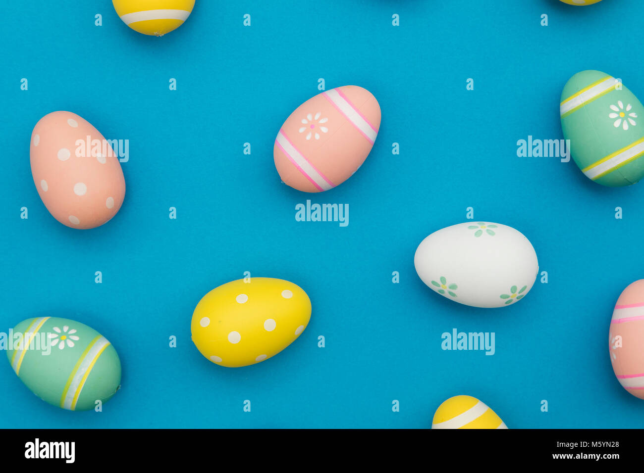 Easter holiday background. Pastel colored decorated easter eggs on a ...