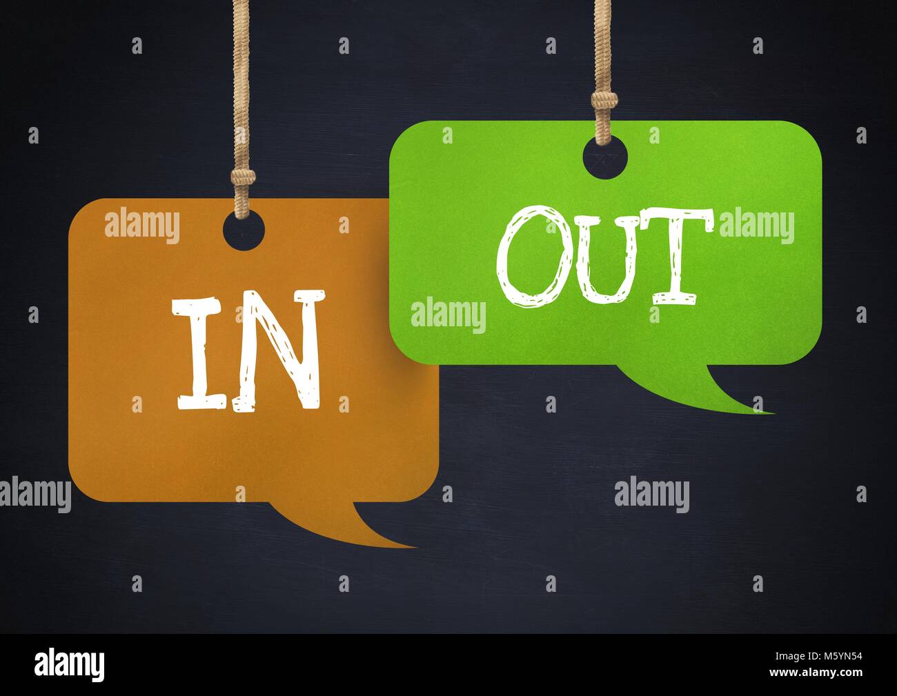 In Out text on hanging paper speech bubbles Stock Photo - Alamy
