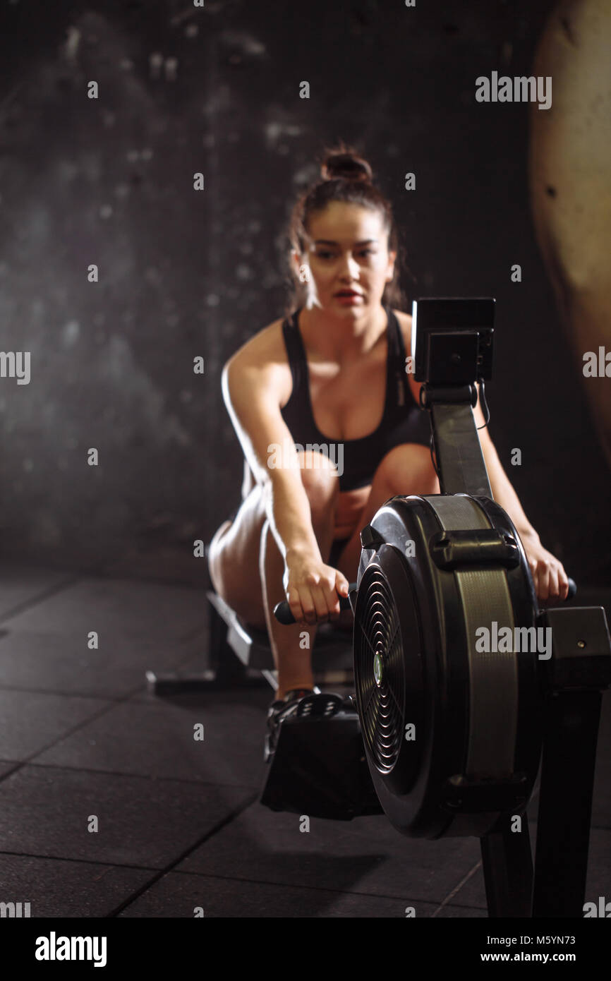 Woman using rowing machine hi-res stock photography and images - Alamy