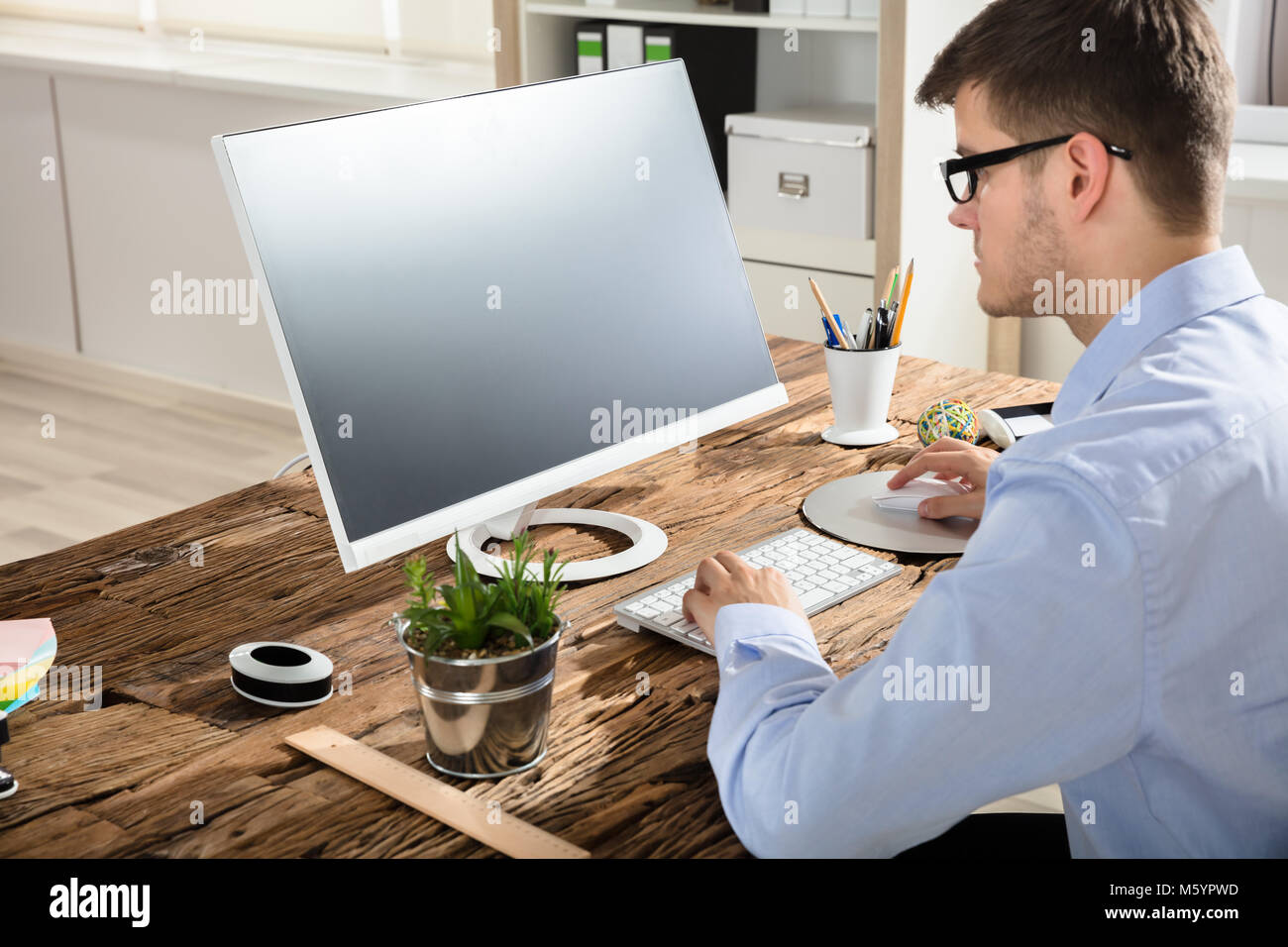 Businessman Using Computer With Black Screen In Office Stock Photo - Alamy