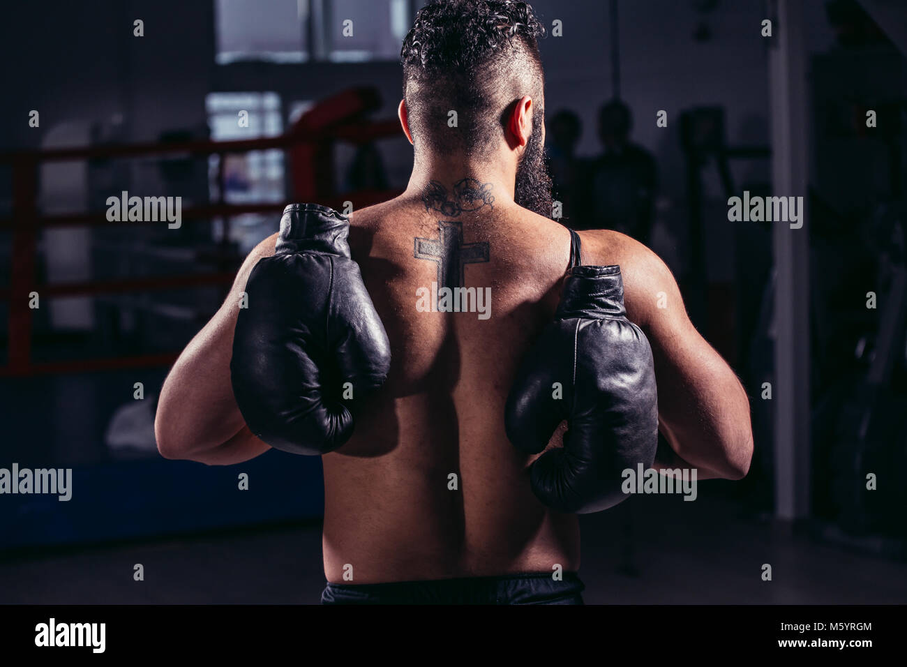 guy back towards camera, pair of boxing gloves over his shoulder Stock ...