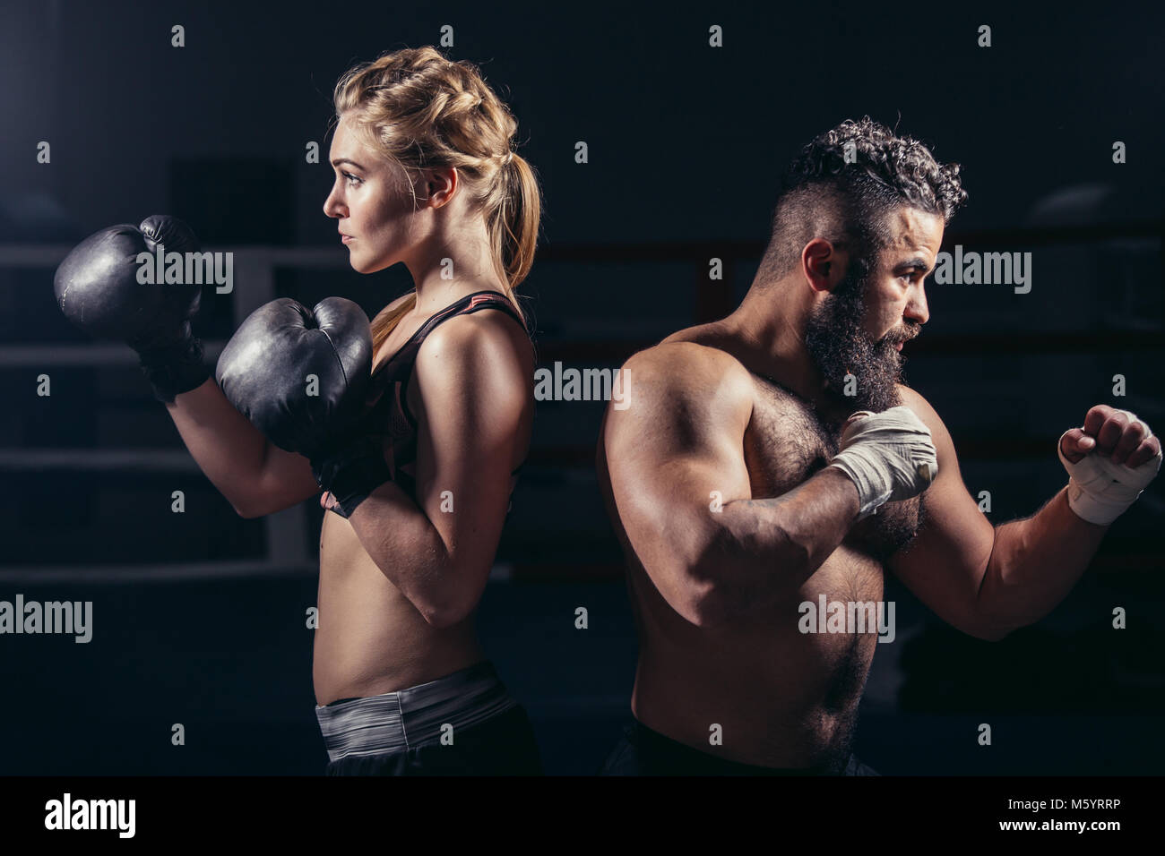 Boxing lessons concept. woman and man hold hands up in boxing gloves ...